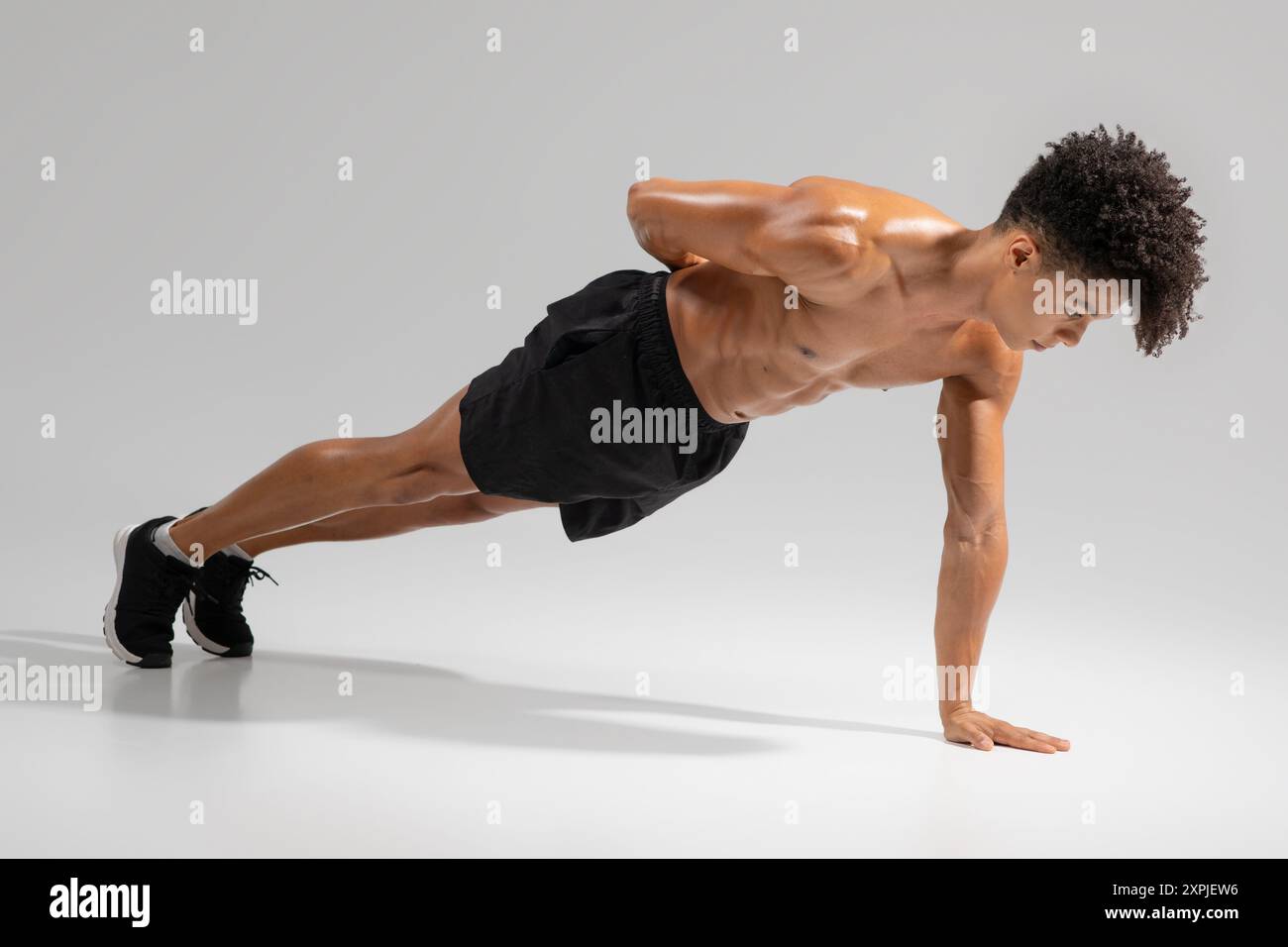 Young Man Performing Dynamic Push-Up Exercise in Fitness Studio Stock ...