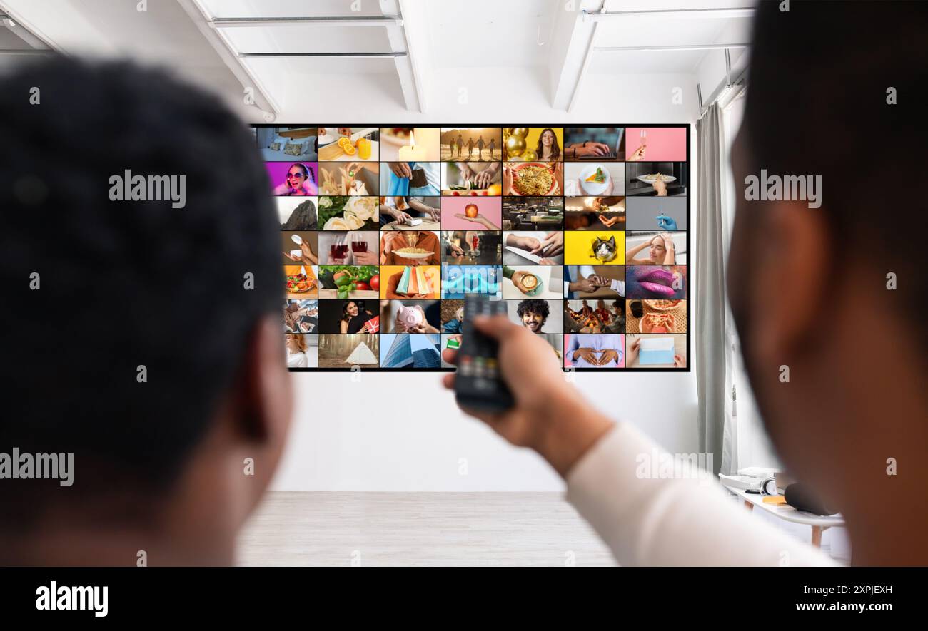 Watching multiple channels on tv hi-res stock photography and images ...