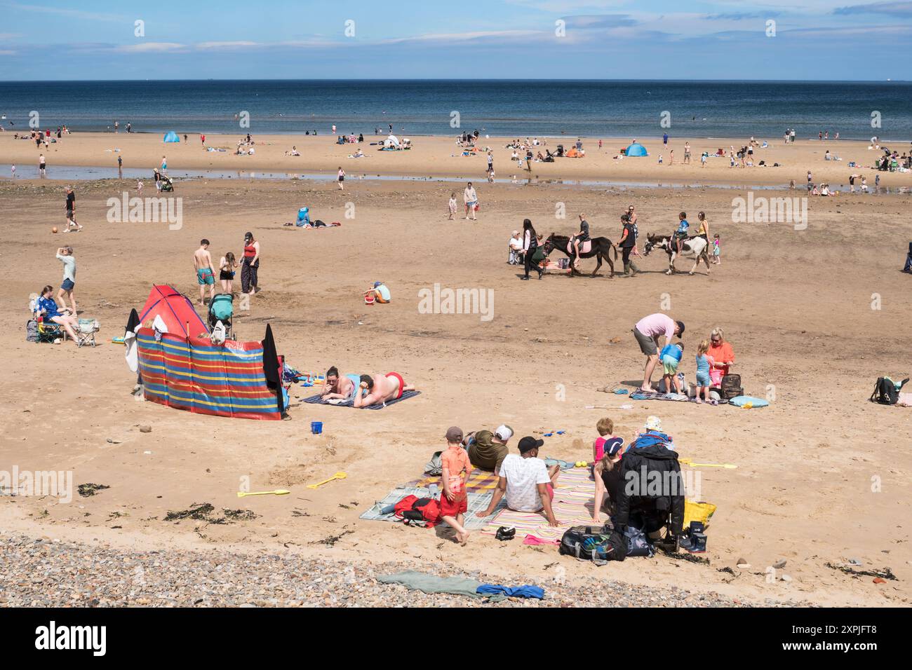 People enjoying summer sunshine on the beach at Saltburn-by-the-Sea ...