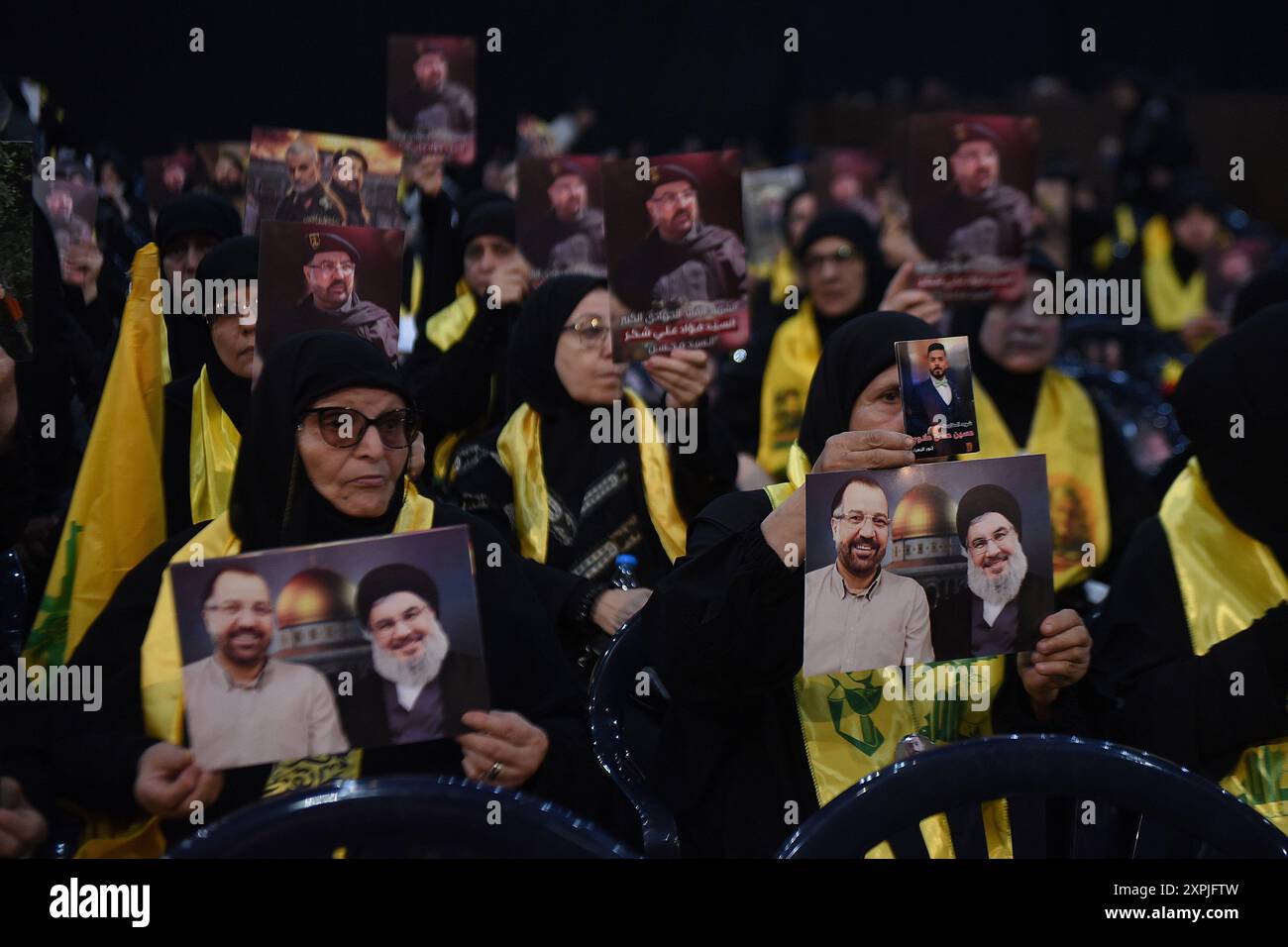 Beirut, Lebanon. 6th Aug, 2024. Hezbollah supporters hold pictures ...