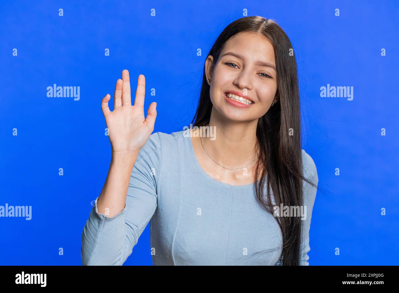 Woman smiling beckoning hands hi-res stock photography and images - Alamy