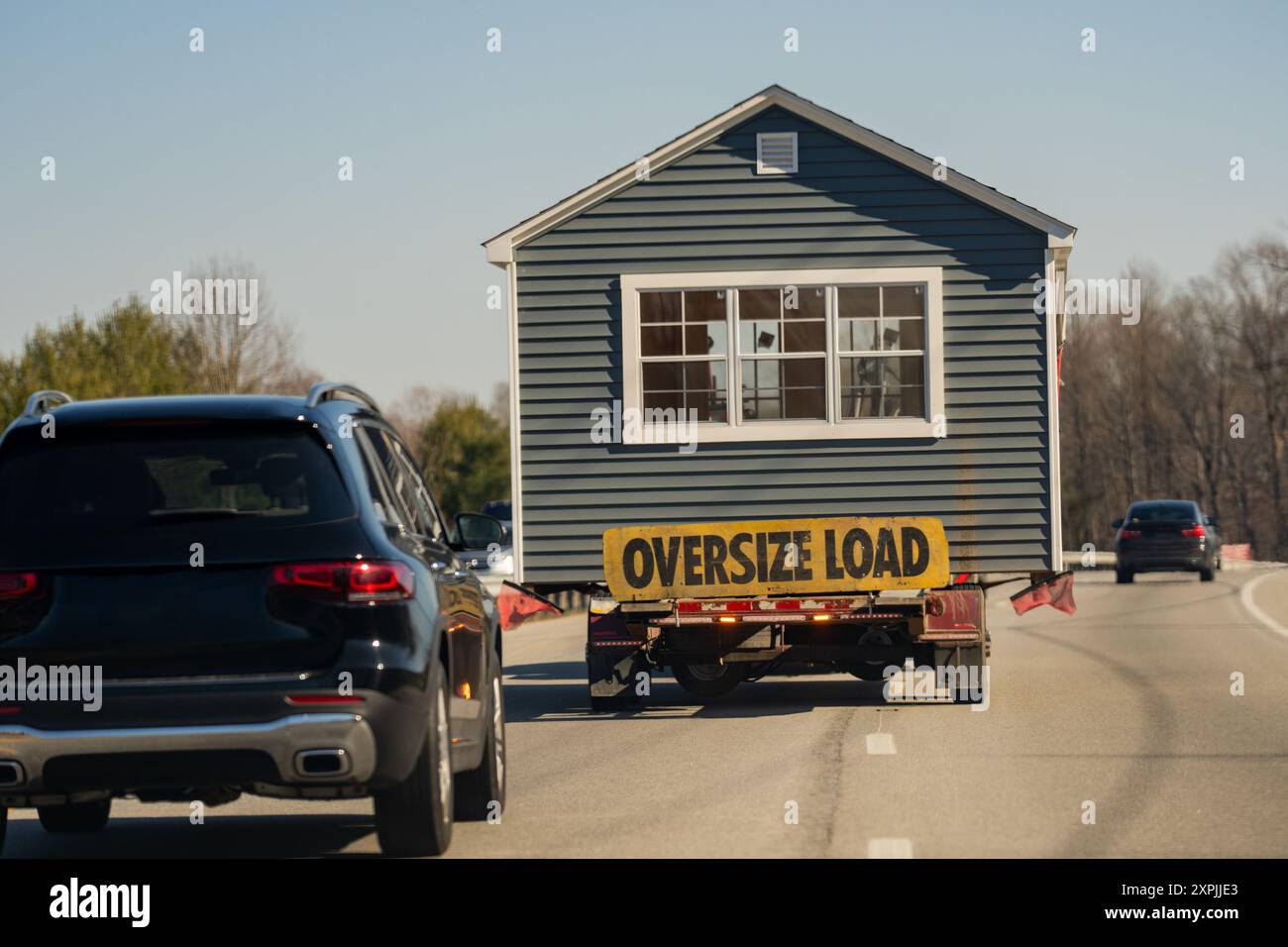 Oversize load home. Manufactured house transported on the highway ...