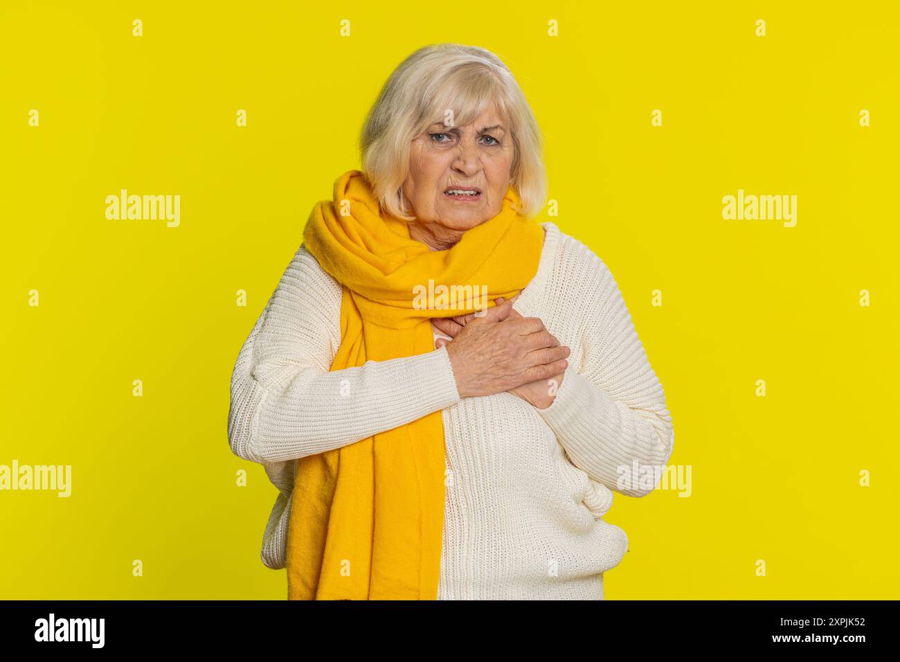 Stressed scared senior woman suffers from tension holding chest with ...