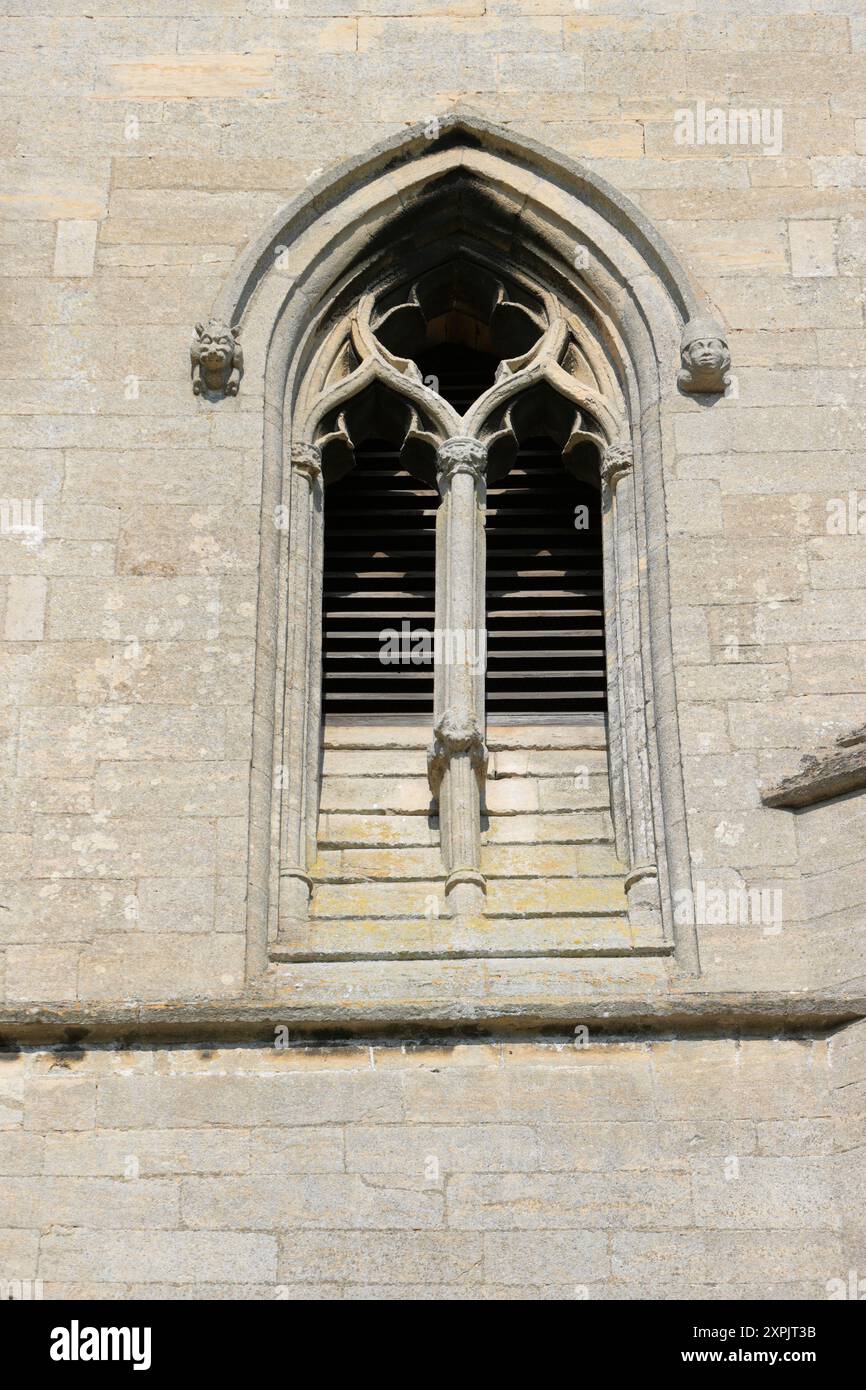 Church belfry with ornamental stonework. dripstone and louvres in ...
