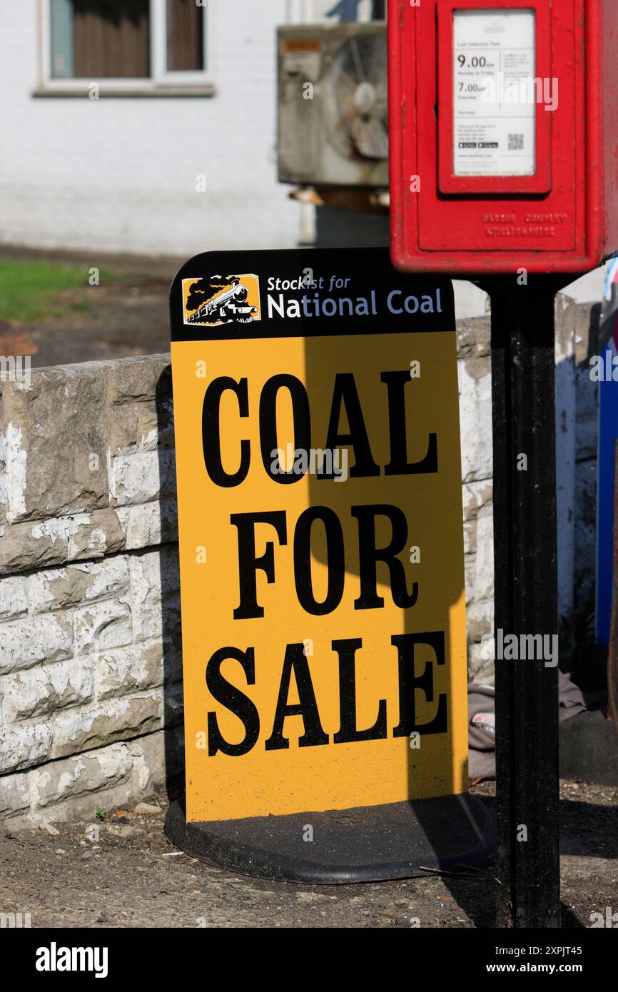 Coal for sale sign next to red post box in Anwick village in ...
