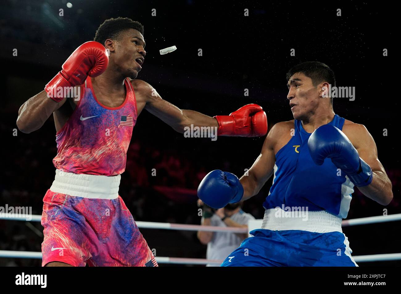 United States' Omari Jones, left, loses his mouth guard as he fights ...