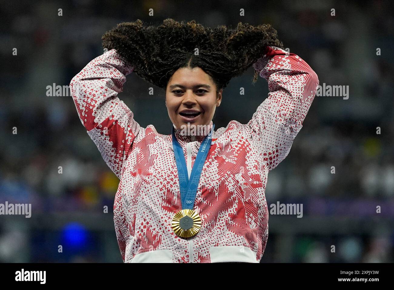 Gold medalist, Camryn Rogers, of Canada, stands on the podium after the ...