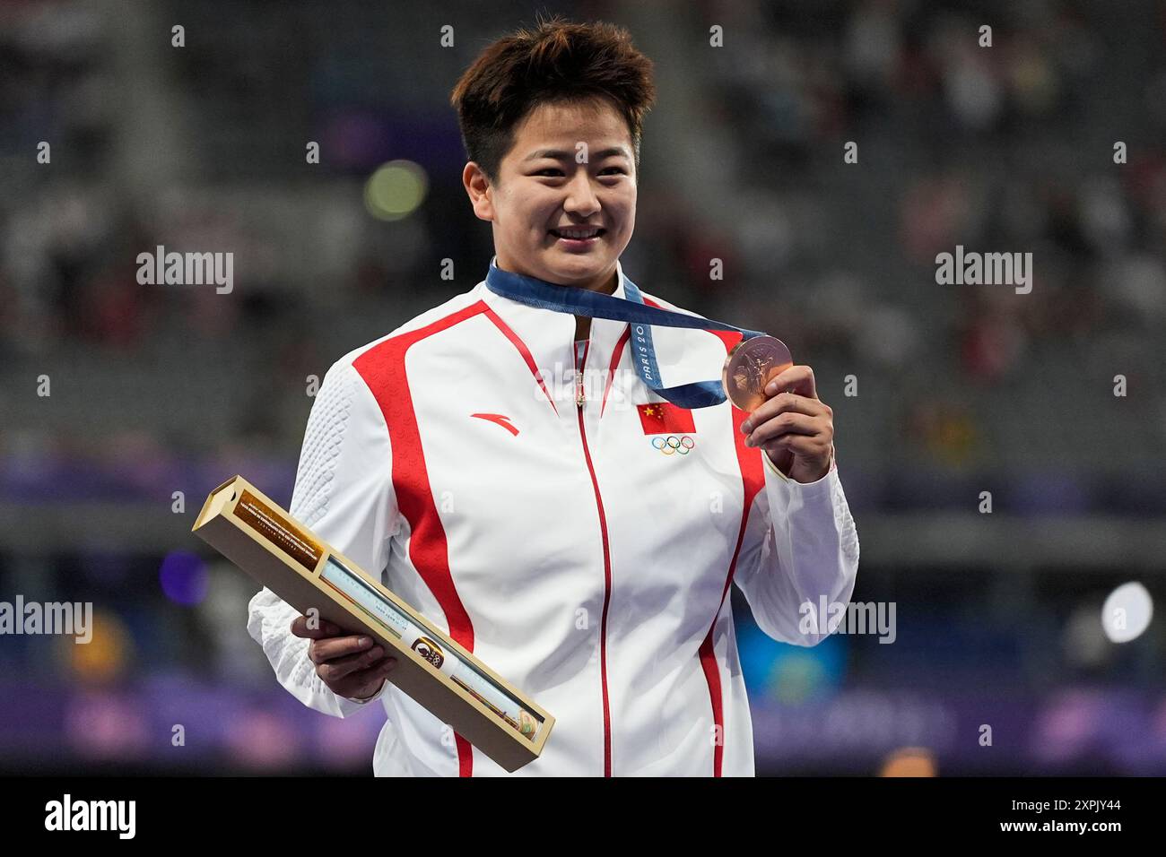 Bronze medalist Zhao Jie, of China, stands on the podium after the ...