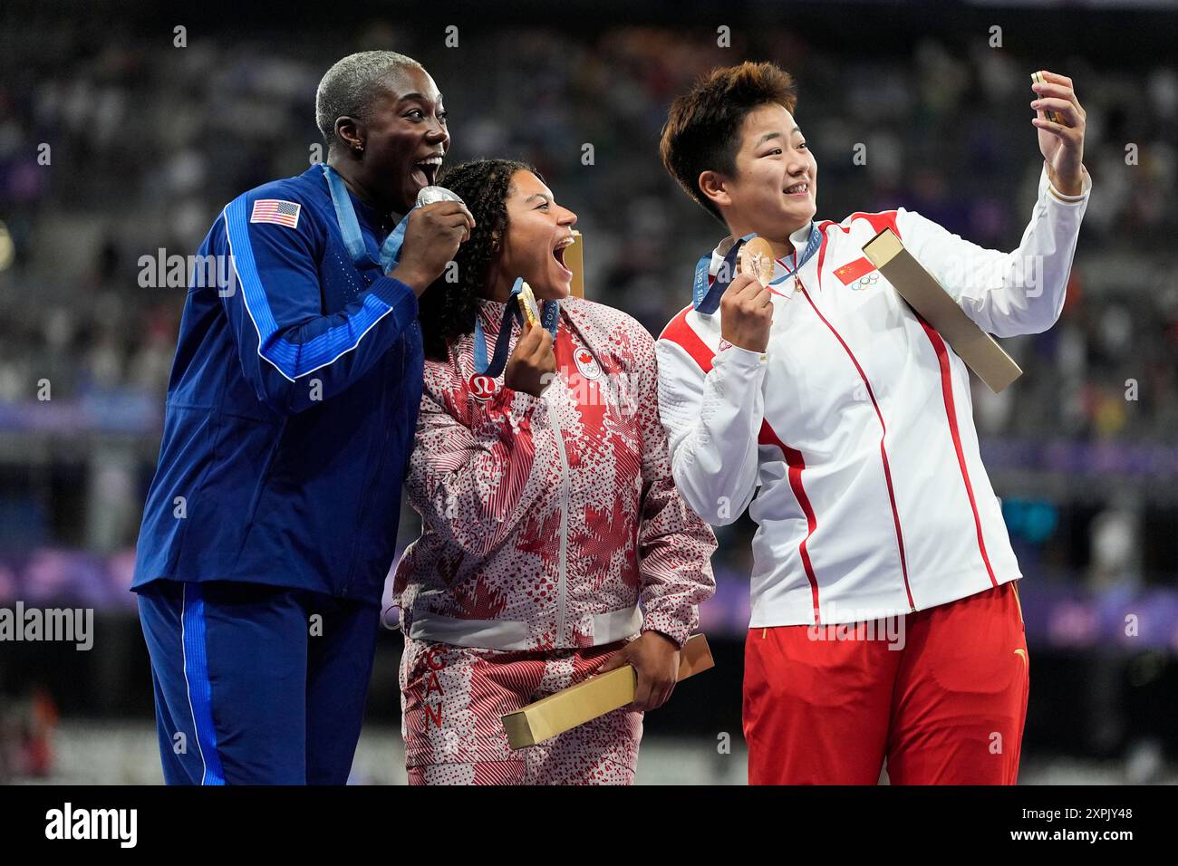 Gold medalist, Camryn Rogers, of Canada, stands with silver medalist ...