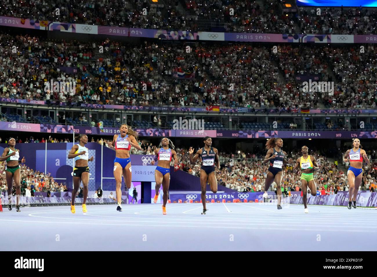 Gabrielle Thomas, third from left, of the United States, reacts after ...