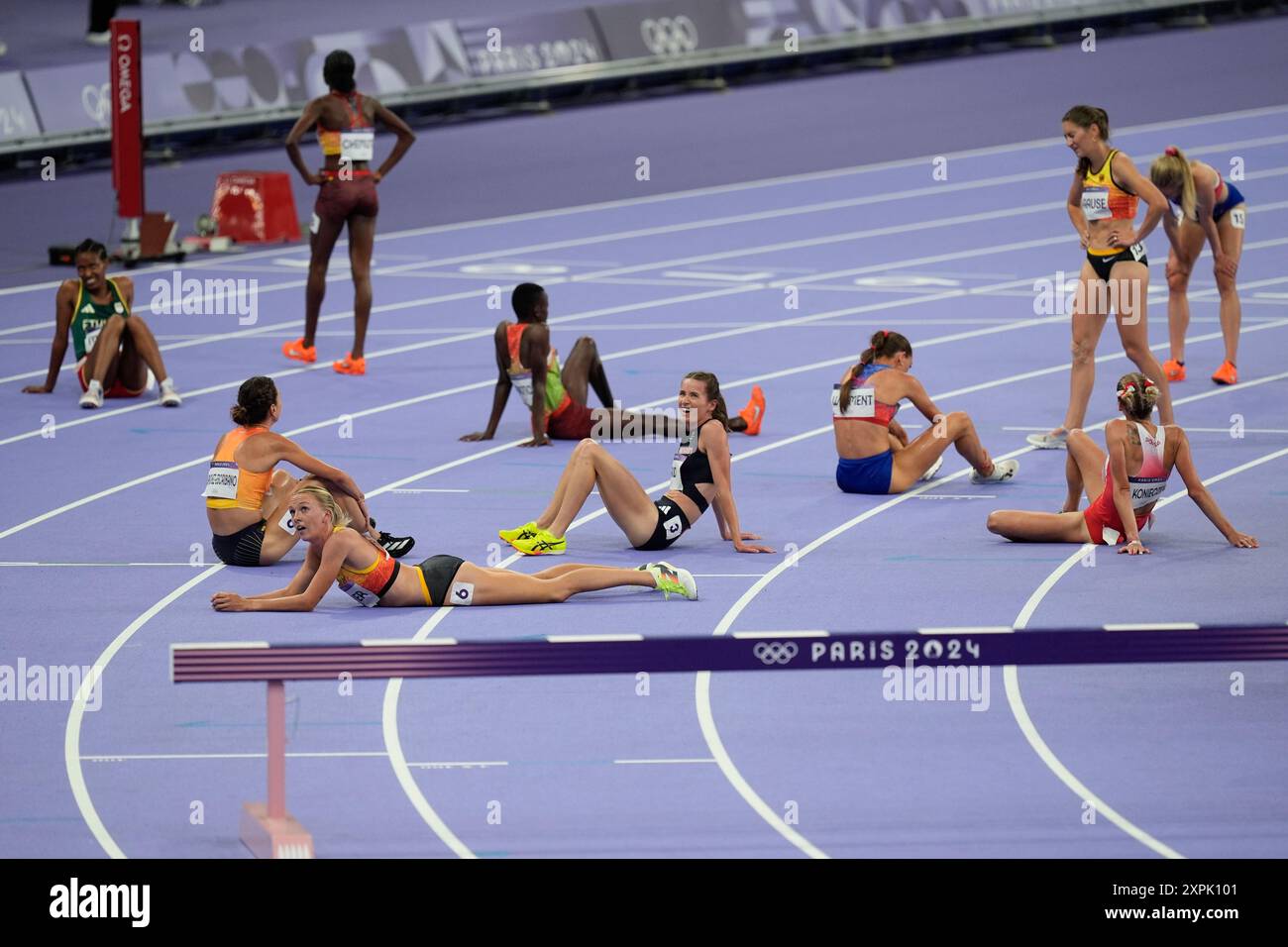 Competitors recover at the end of the women's 3000-meter steeplechase ...