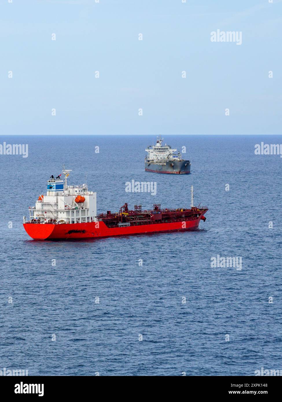 Shipping at sea, two ships moving in different directions, blue sky ...