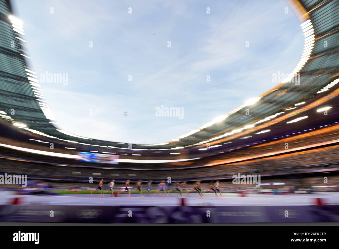 In this image taken with a slow shutter speed, athletes run in the men ...