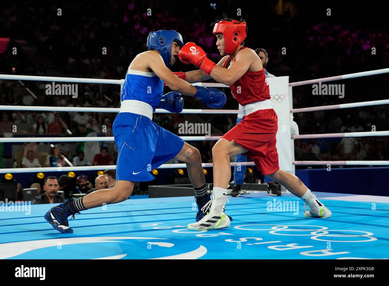 Thailand's Janjaem Suwannapheng, right fights Algeria's Imane Khelif in ...