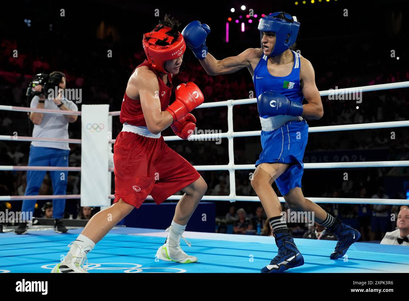 Thailand's Janjaem Suwannapheng, left, fights Algeria's Imane Khelif in ...