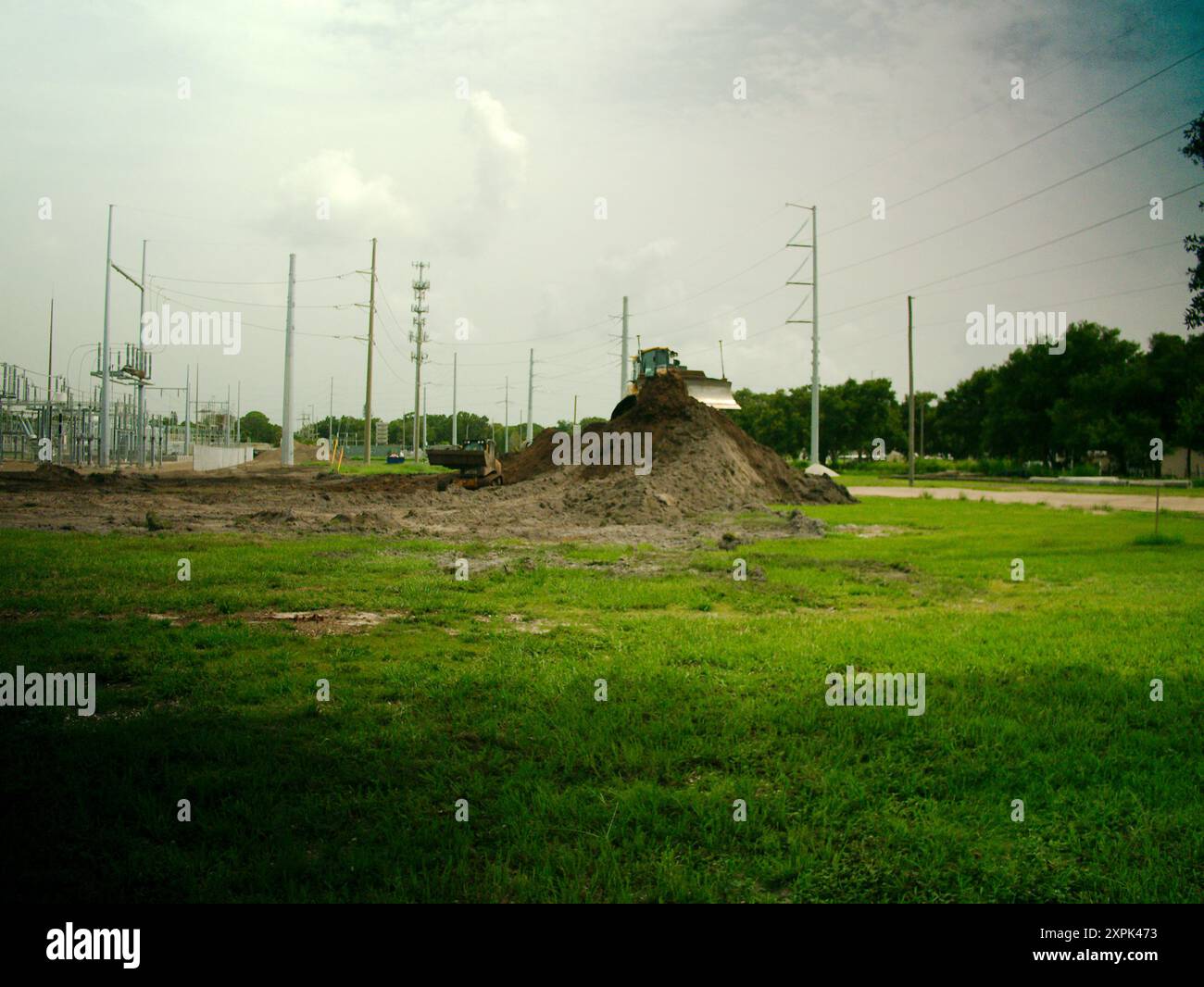 Construction brown dirt piles, bulldozer moving piles of dirt in an ...