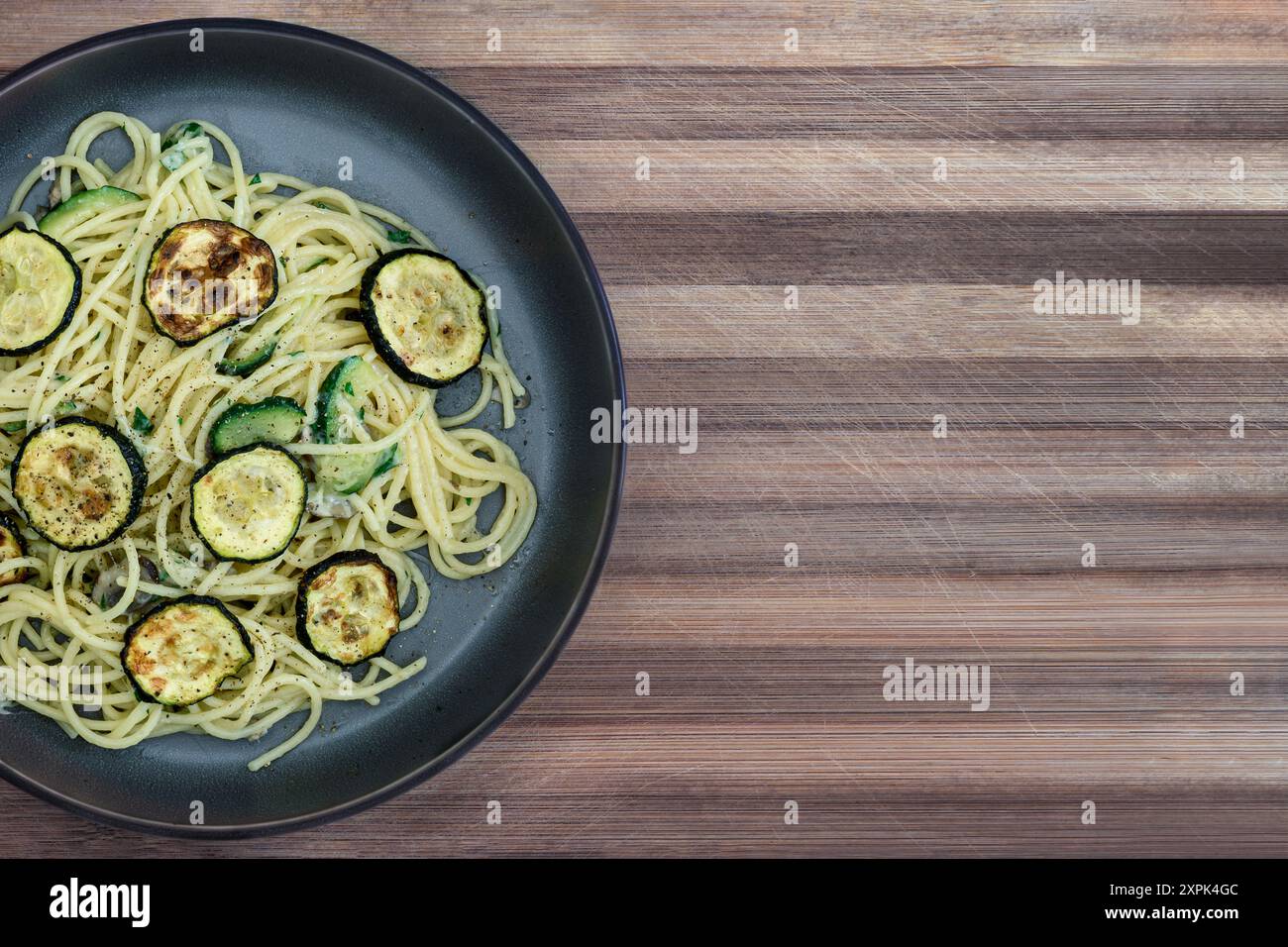 Flat lay photo of zucchini pasta spaghetti with on a rustic cutting ...