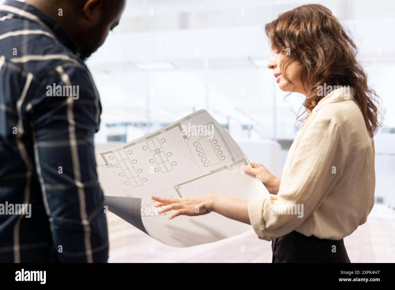 Realtor and business entrepreneur examining blueprints for a high class ...