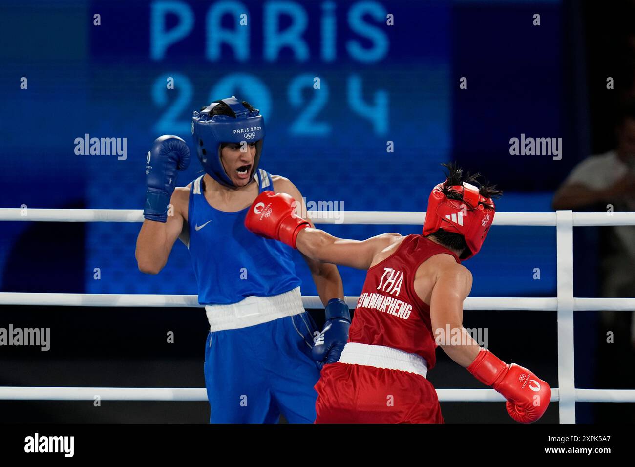 Thailand's Janjaem Suwannapheng, right, fights Algeria's Imane Khelif ...