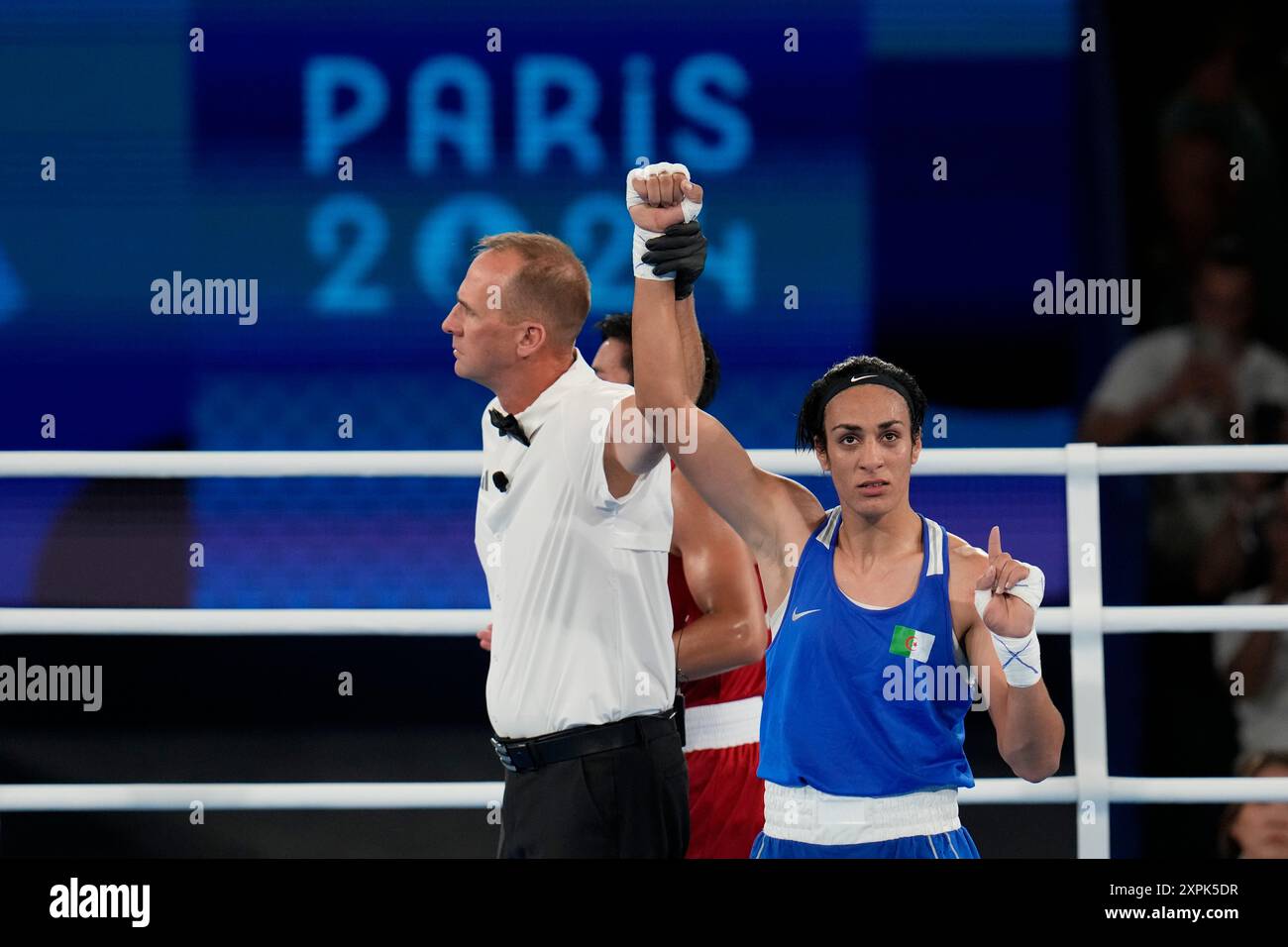 Algeria's Imane Khelif reacts after defeating Thailand's Janjaem ...