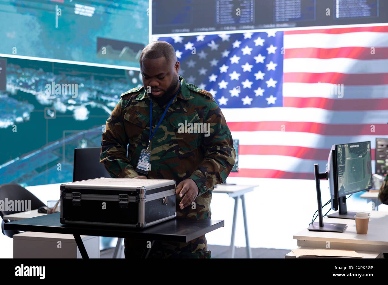 Military specialists in a control center monitor global security operations, manage surveillance ...