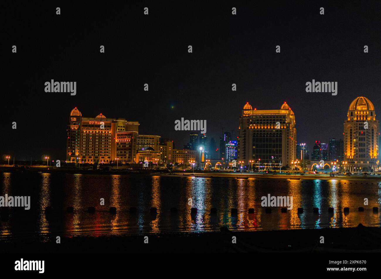 Night view of Doha Corniche as seen from Qatara Stock Photo - Alamy