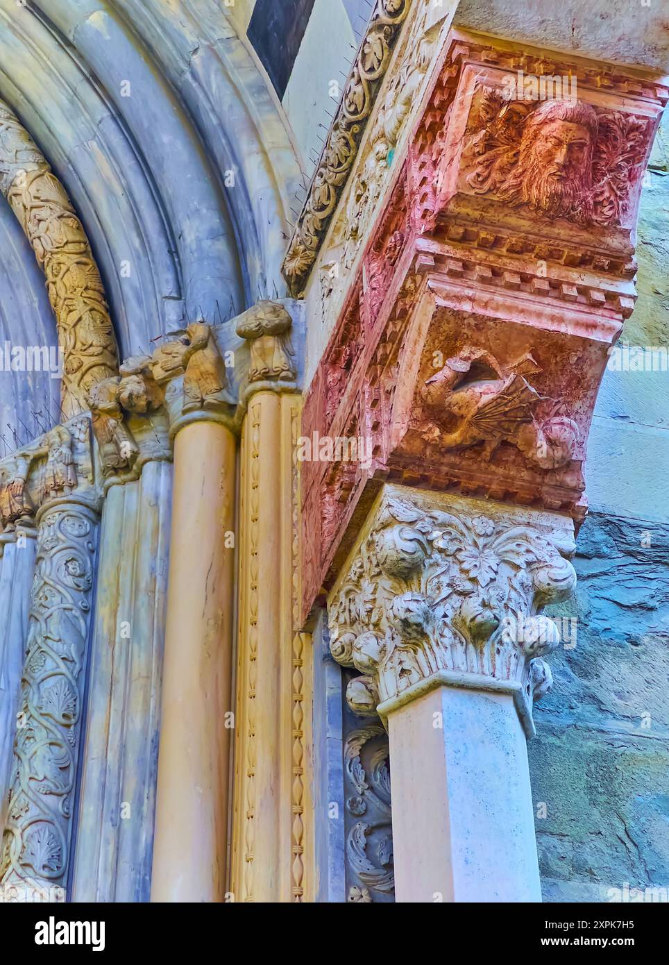 The complex sculptured column capital of white and red stone, Porta dei ...