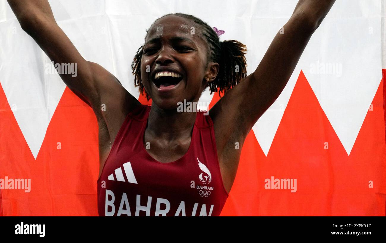 Winfred Yavi, of Bahrain, celebrates with her national flag after ...
