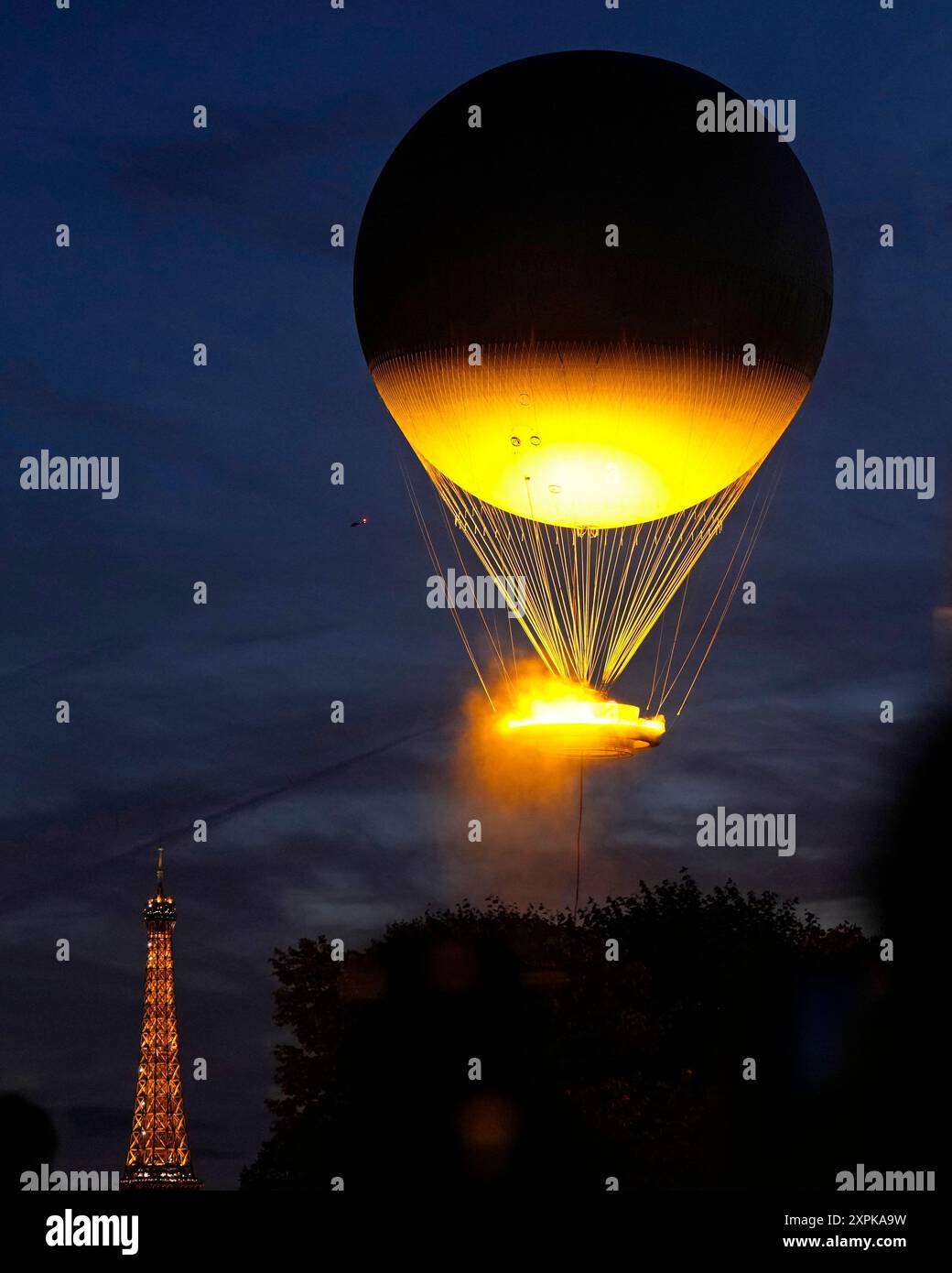 The balloon carrying the Olympic cauldron rises above Tuileries Garden ...