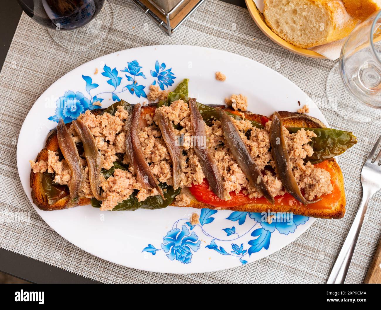Traditional Spanish toasted bread with tuna, anchovy and baked pepper ...