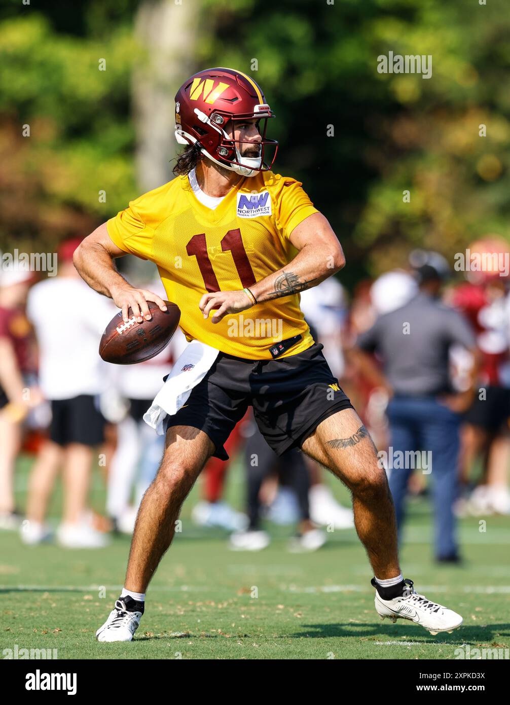 Washington Commanders quarterback Sam Hartman (11) performing drills ...