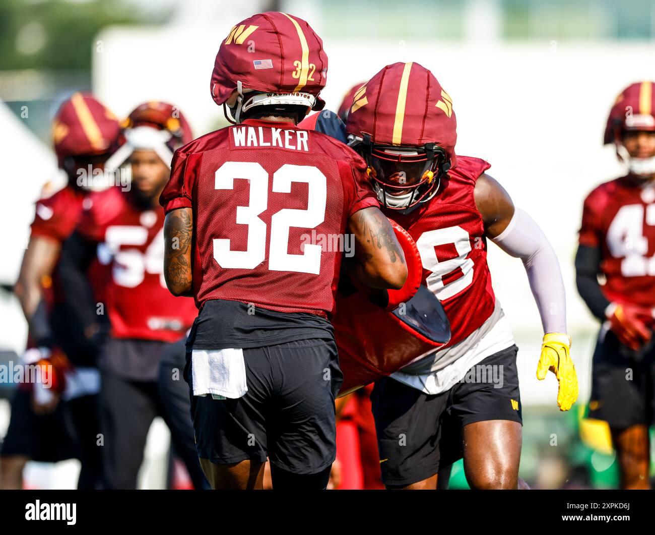 Washington Commanders line backer Mykal Walker (32) and Jordan Magee ...