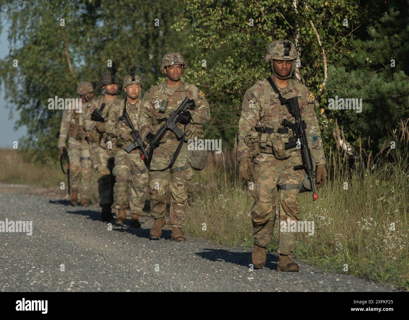 U.S. Soldiers, assigned to the 2nd Theater Signal Brigade, walk along ...