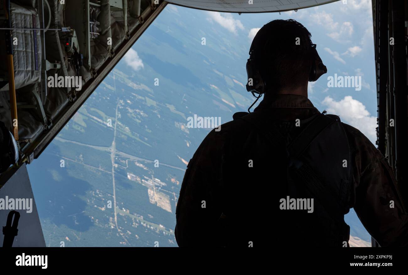 A loadmaster assigned to the 6th Special Operations Squadron looks out the back of an U.S. Air ...