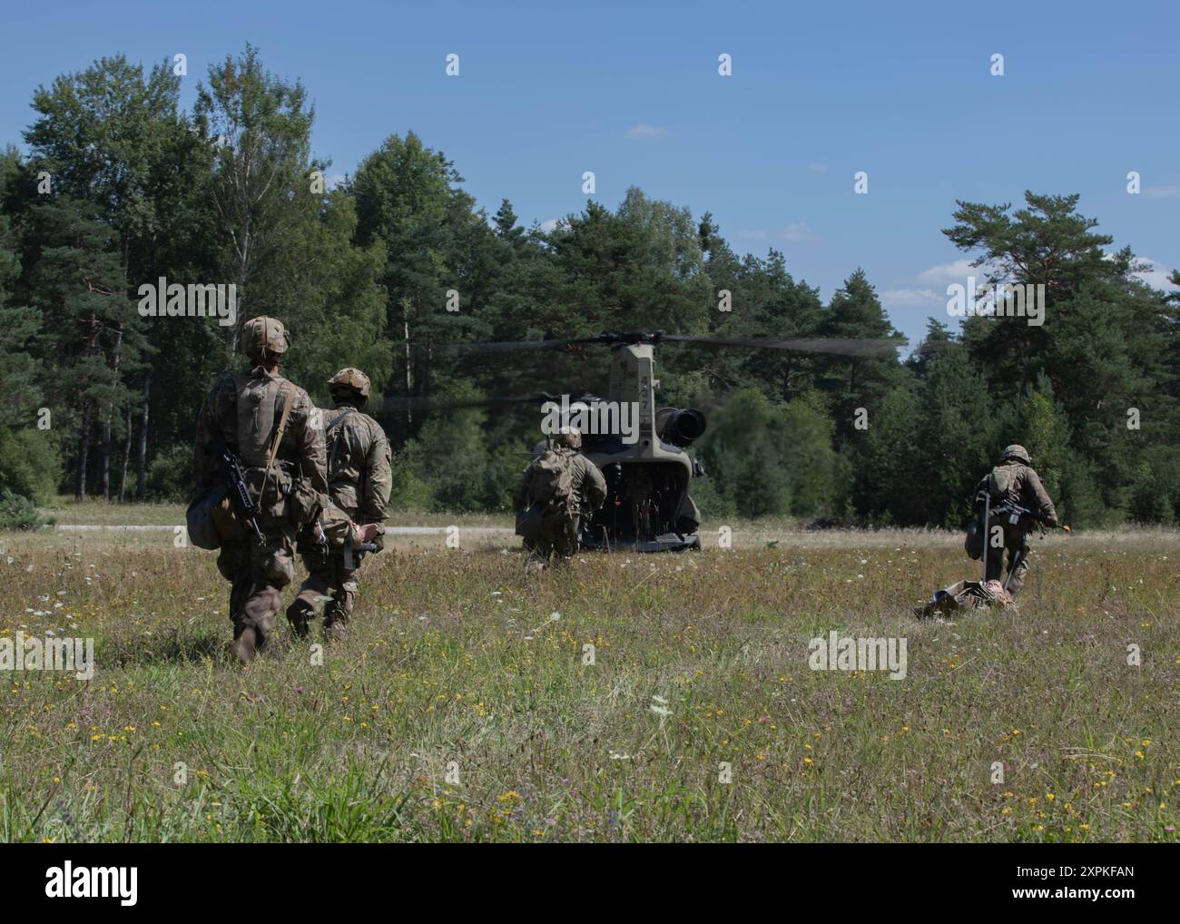 U.S. Soldiers, assigned to V Corps, carry a pair casualty care manikins ...