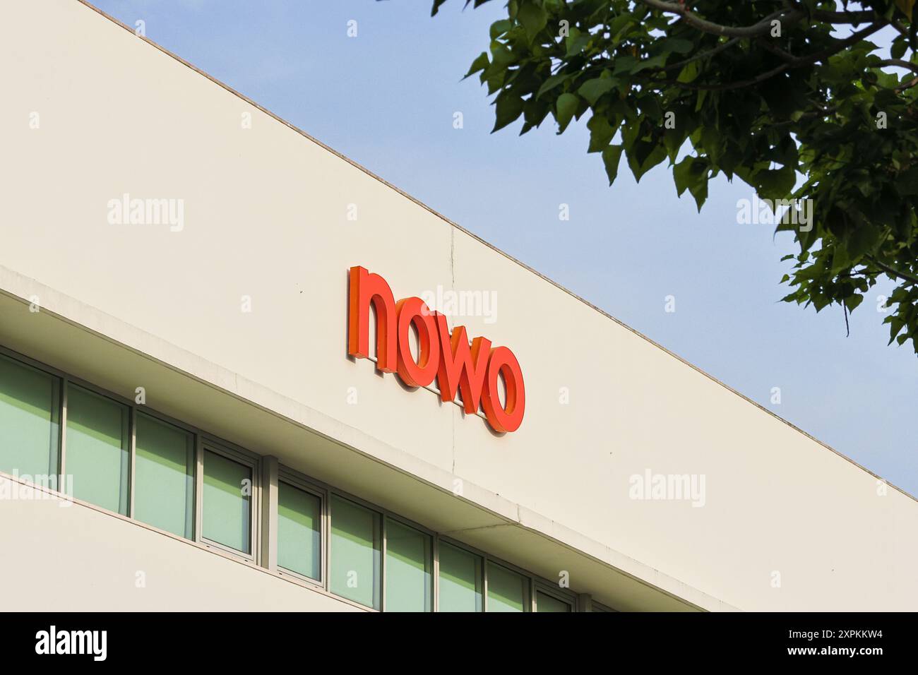 Exterior view of nowo communications signage on building facade at nations' park in lisbon ...