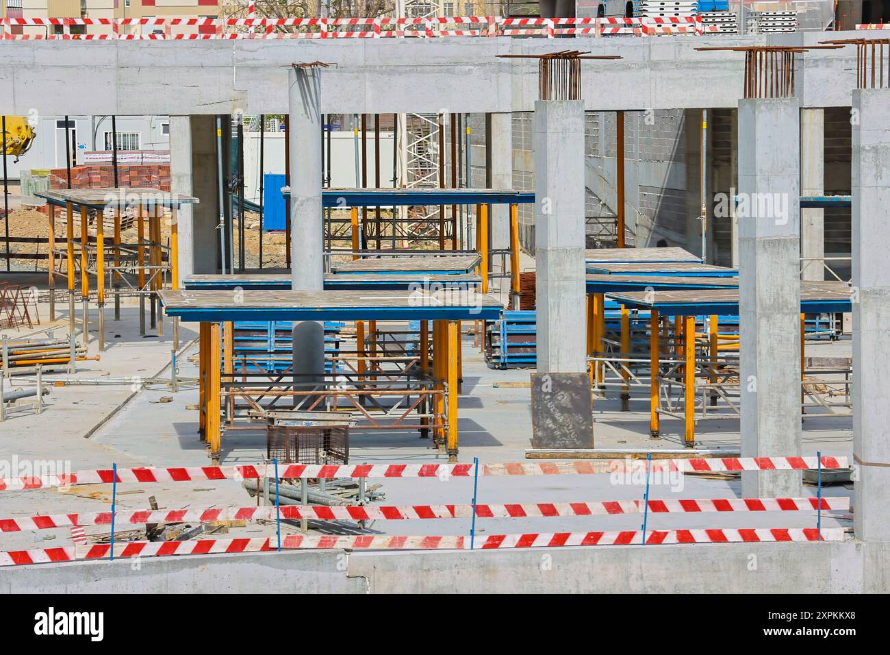 Structural concrete pillars with scaffolding on an active construction ...