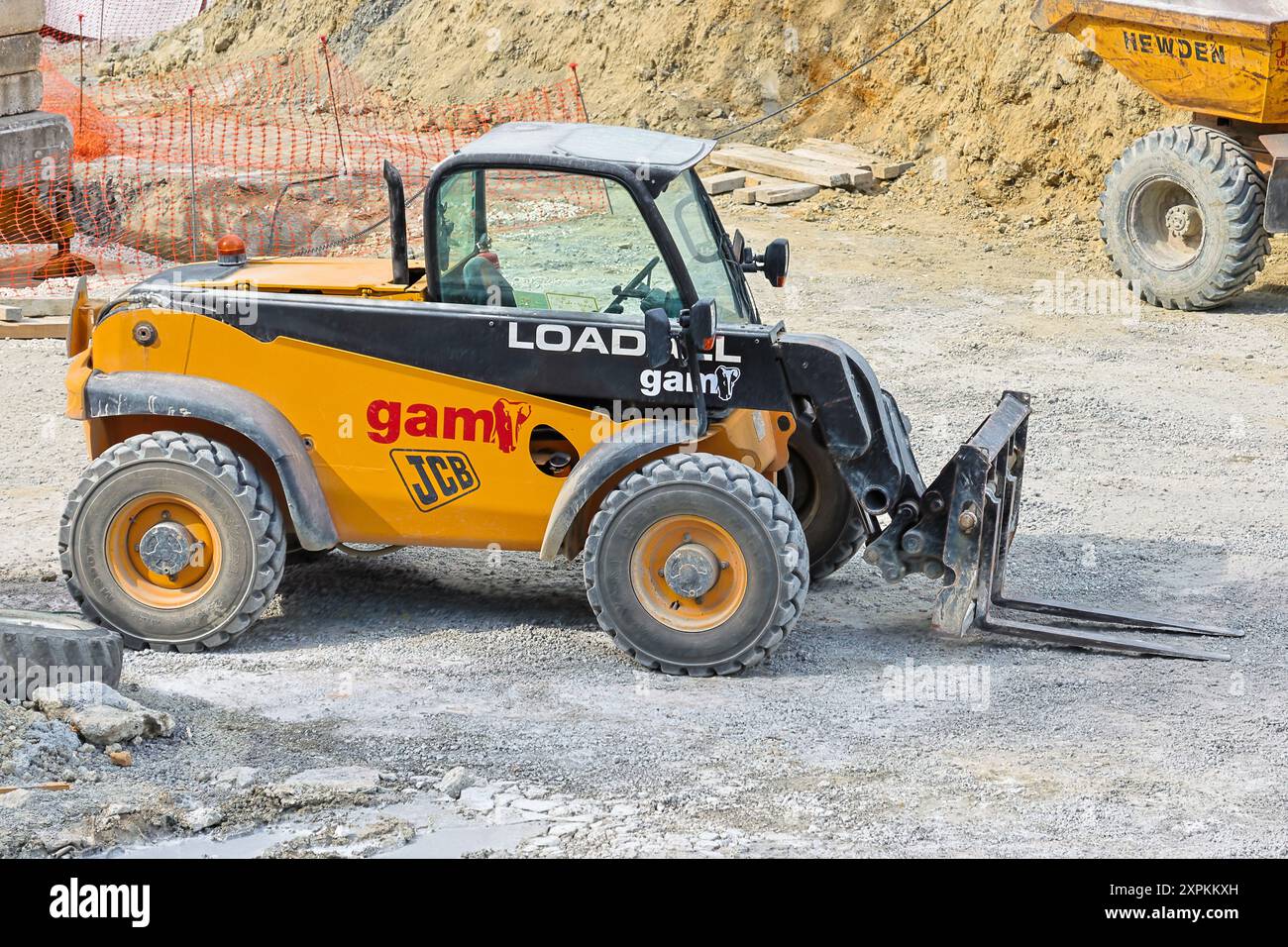 Small wheel loader with a bucket attachment on a construction site ...