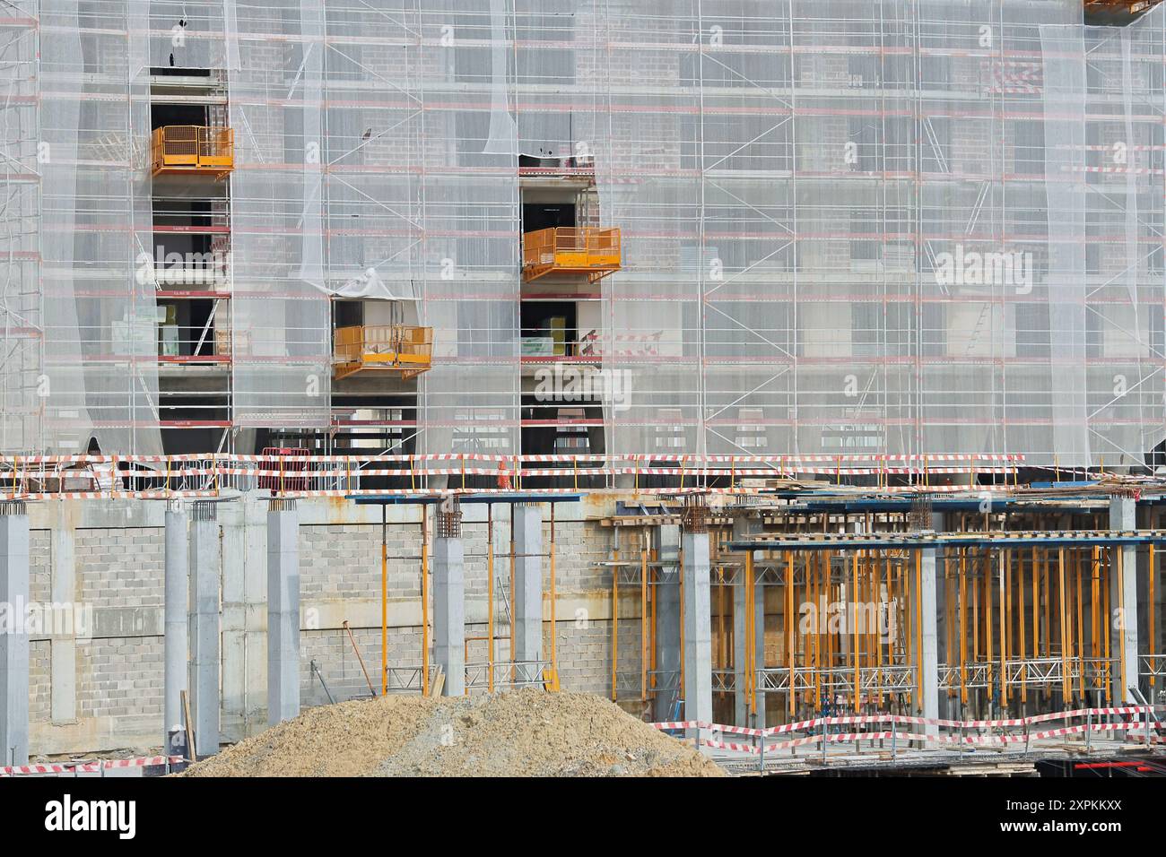 Urban construction zone with scaffolding, safety features, and building ...