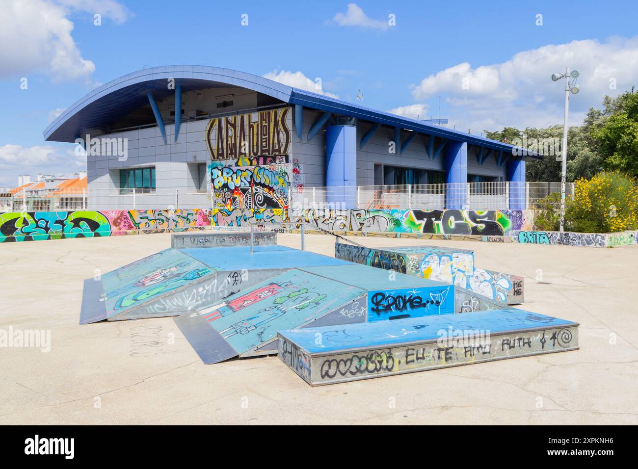 Skate ramps are standing on a concrete surface in a skatepark full of ...