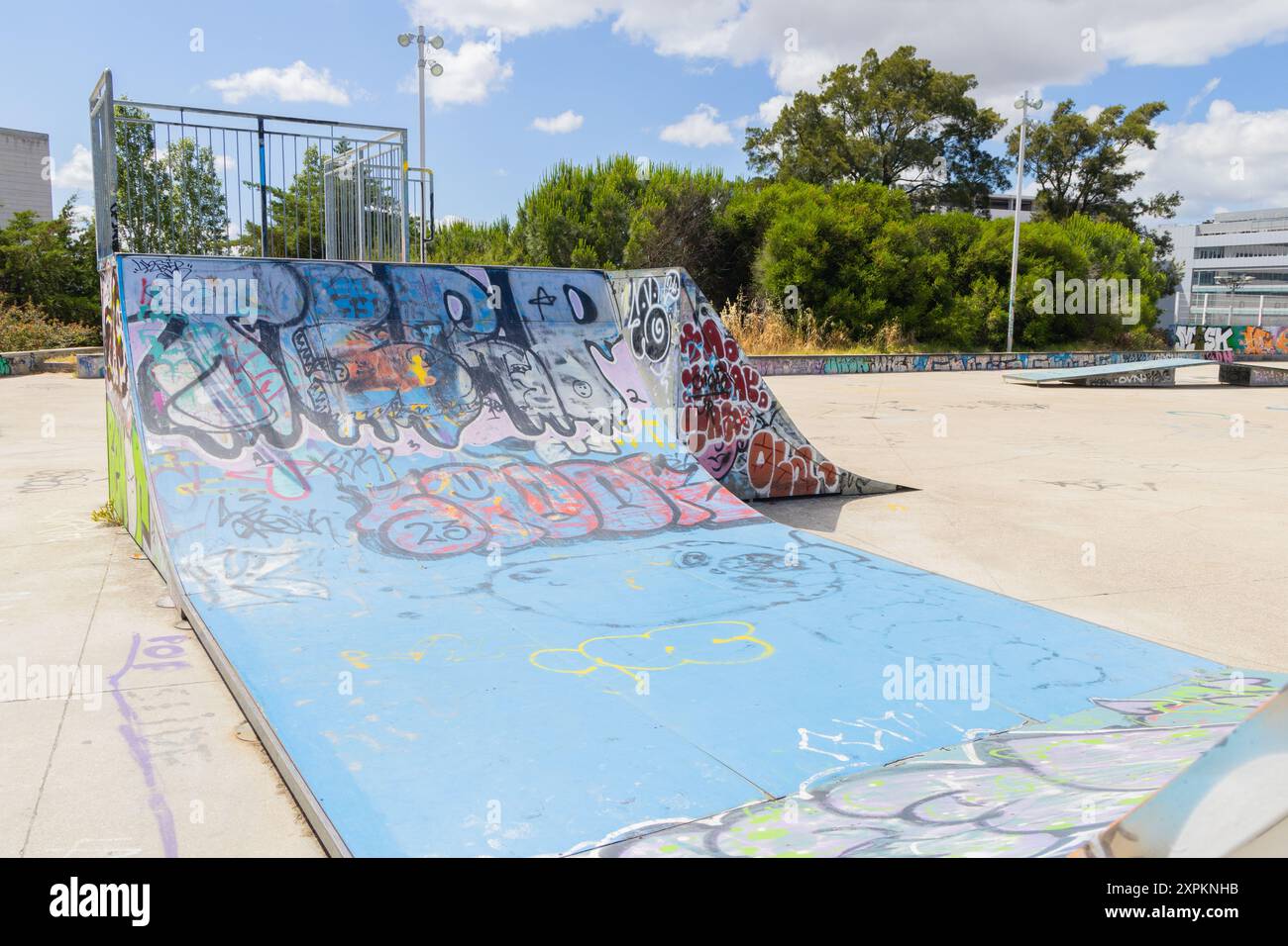Skate ramps are covered in graffiti in an empty urban skatepark Stock ...