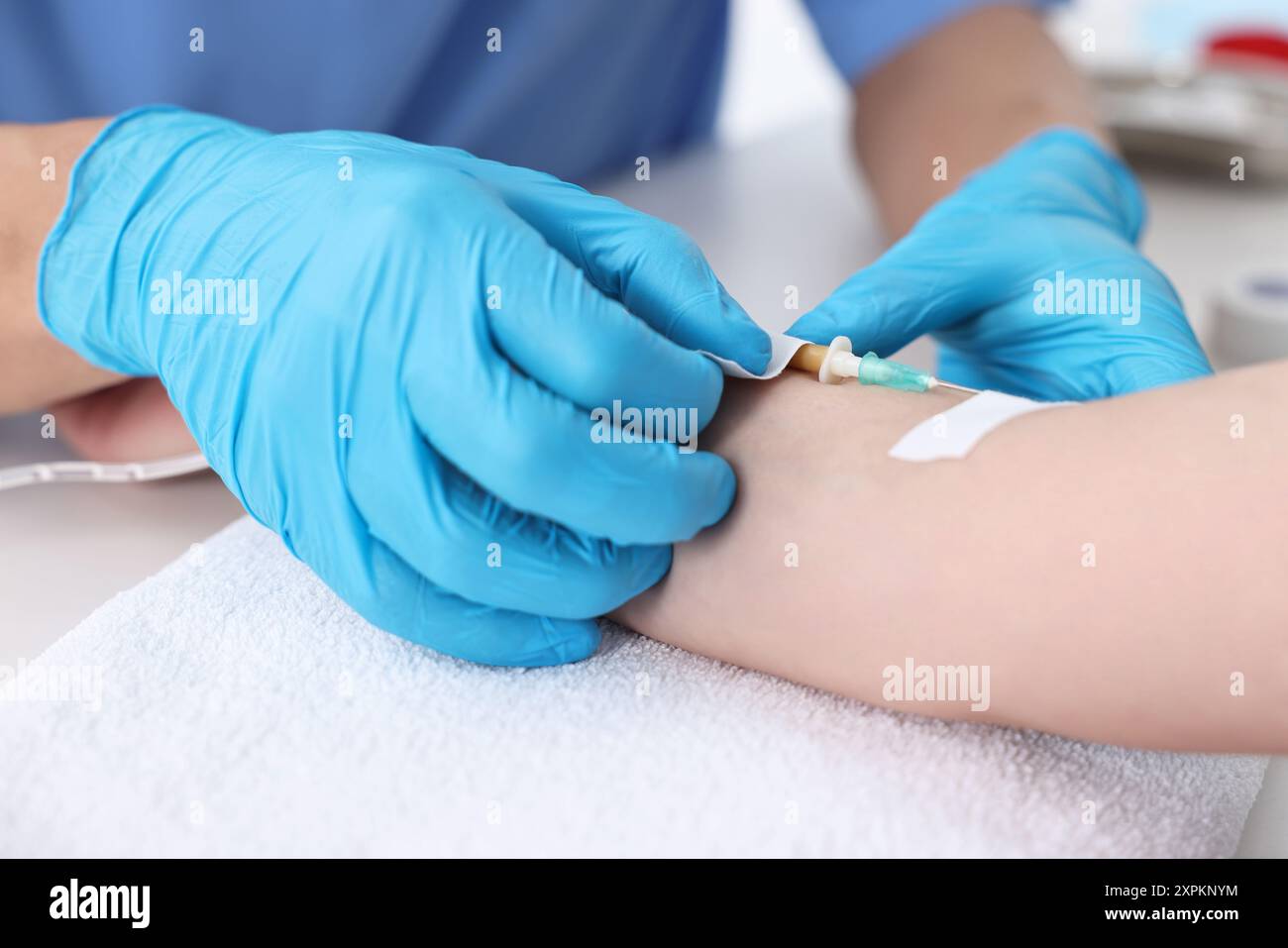 Nurse inserting IV into arm of patient in hospital, closeup Stock Photo ...