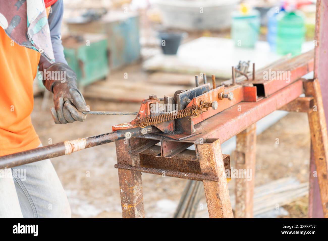 Worker is bending rebars with deformation patterns.in the construction ...