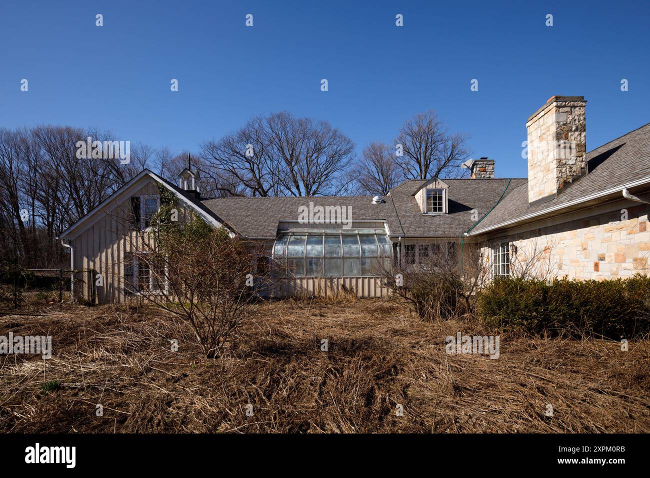 A green house attached to a large abandoned home built in the 1960s ...