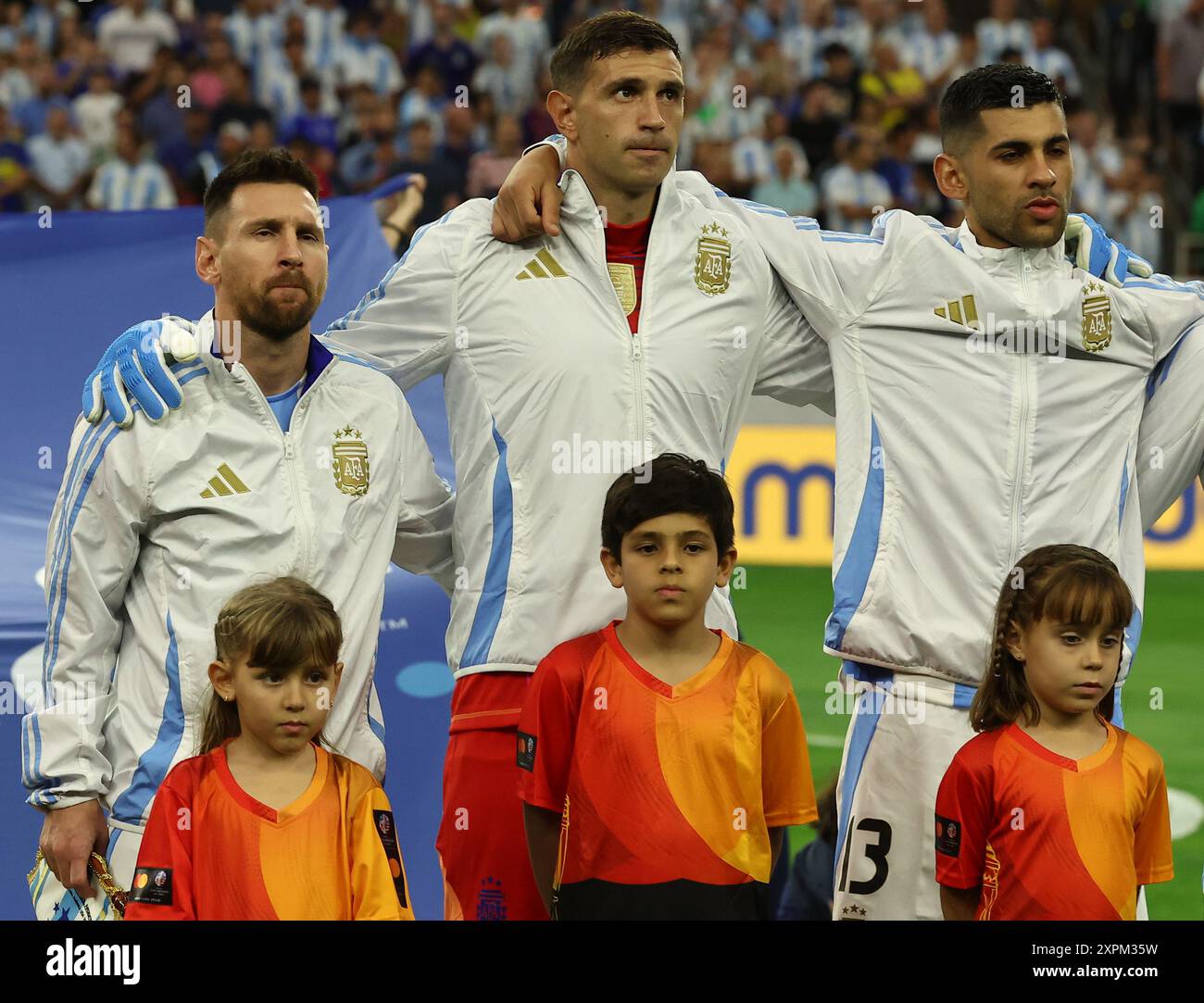 (L to R) Argentina's forward Lionel Messi, goalkeeper Emiliano Martinez ...