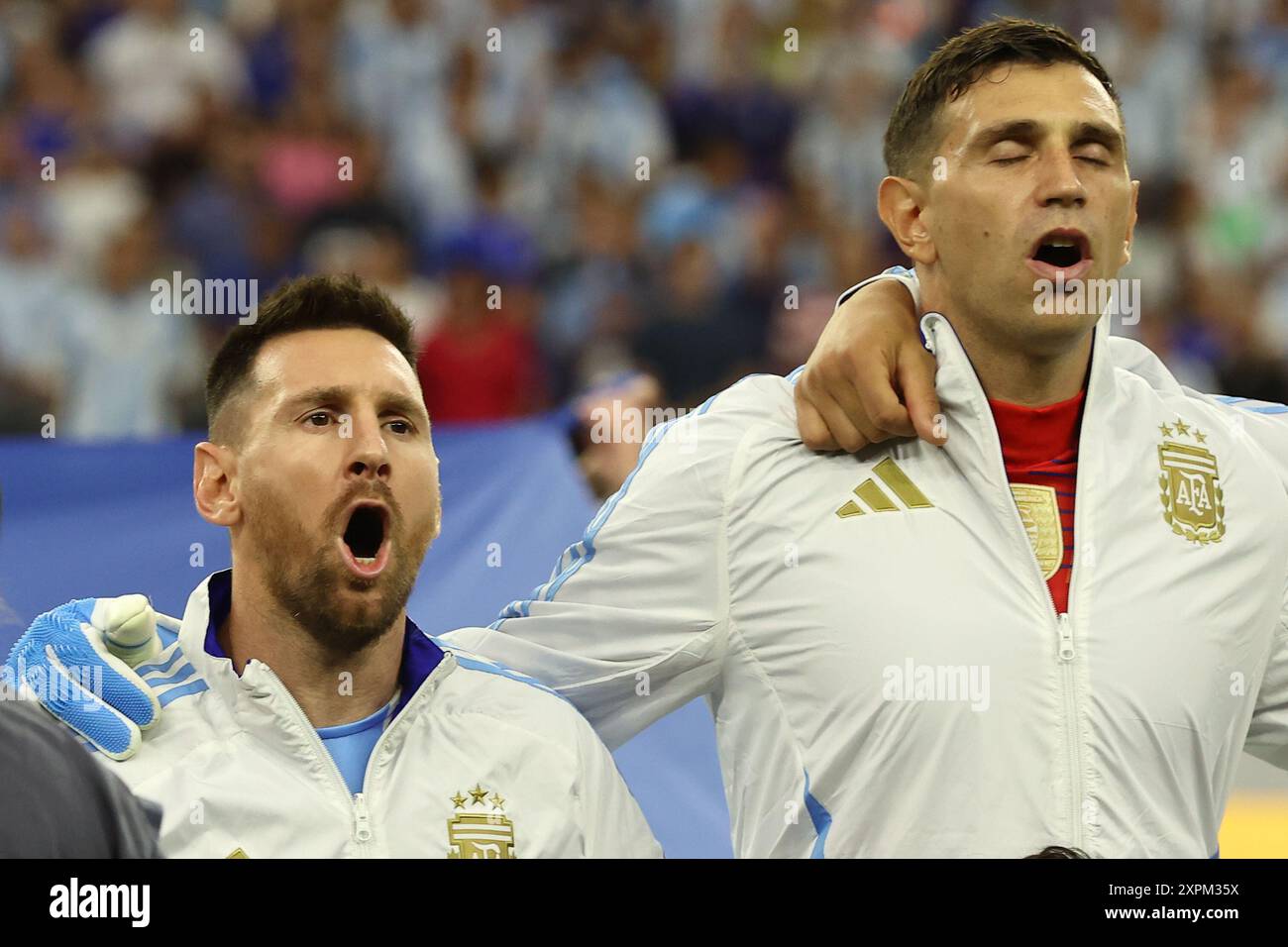 Argentina's forward Lionel Messi (L) and goalkeeper Emiliano Martinez ...