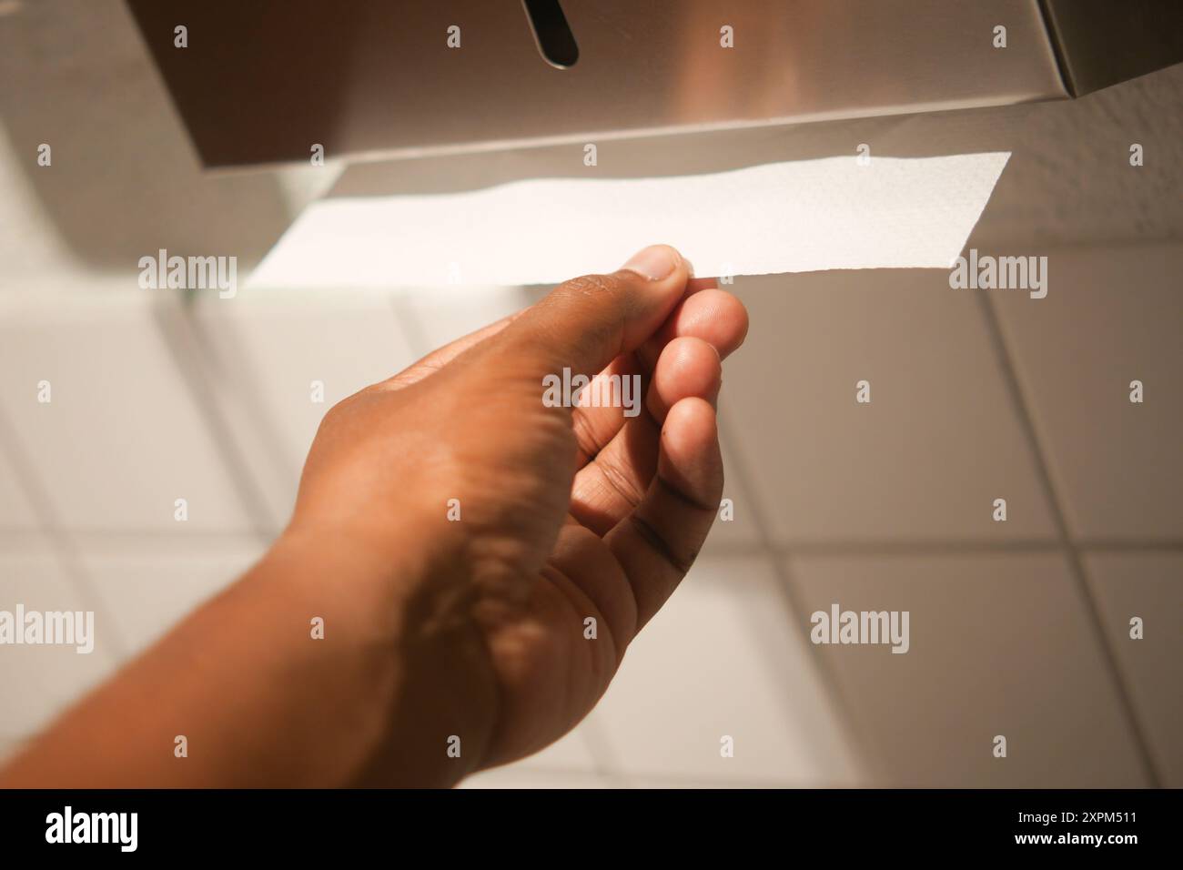 Hand Using Paper Towel Dispenser in a Hygienic Public Restroom with ...