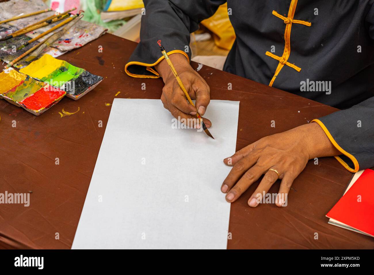 Human using traditional calligraphy brush pen painting lotus flower ...