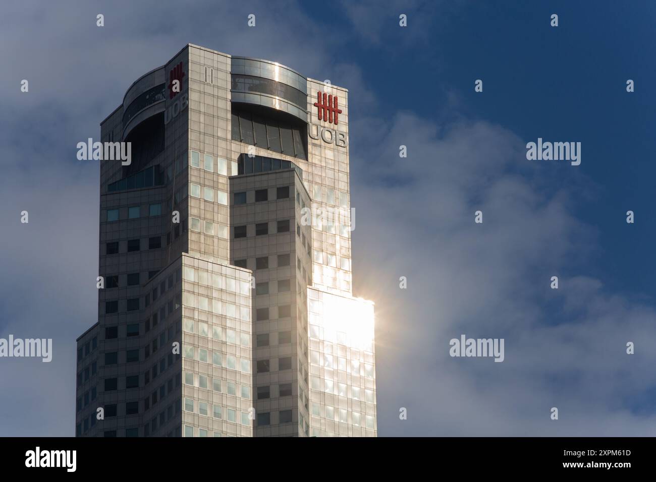 Top of UOB plaza skyscraper building reflect strong lighting from the ...