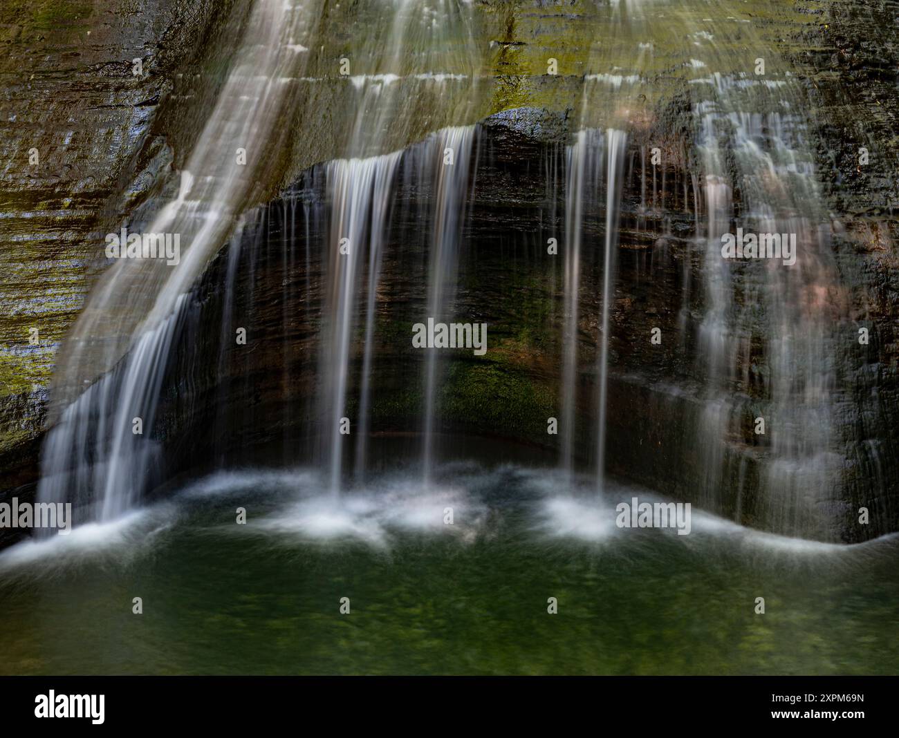 Falls cascade over a water carved "cave" in the gorge wall, Buttermilk ...